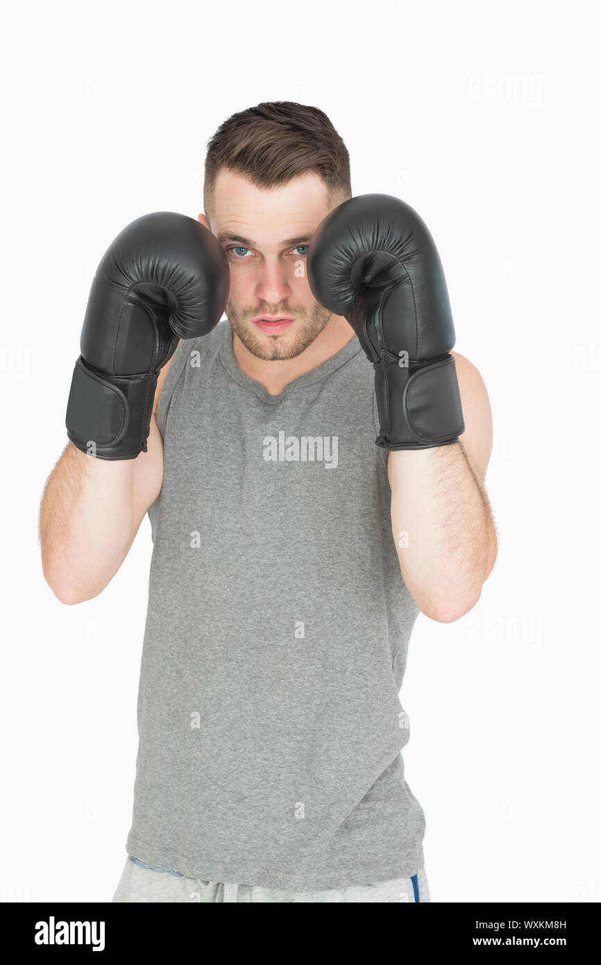 Portrait of young man in boxing stance over white background Stock ...