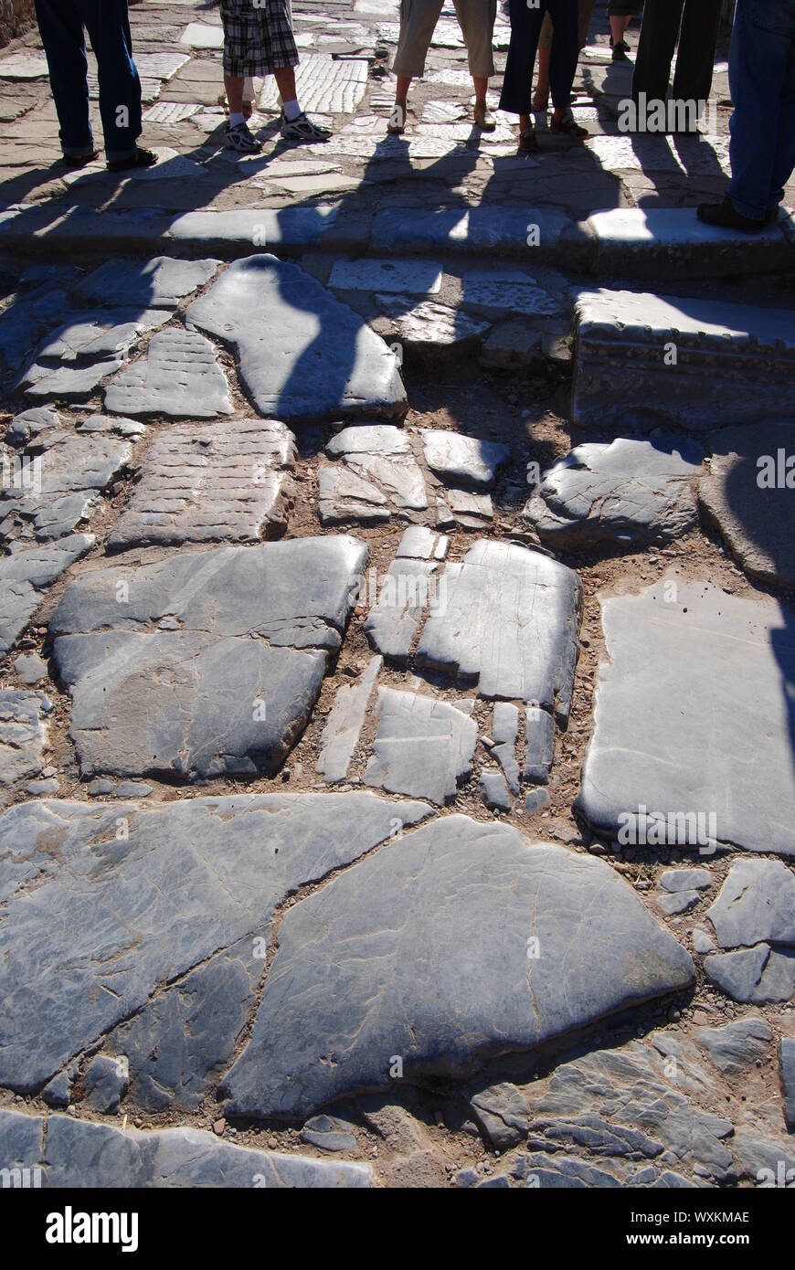 Stone pavement in a city. patterned stone pavement. People shadows ...
