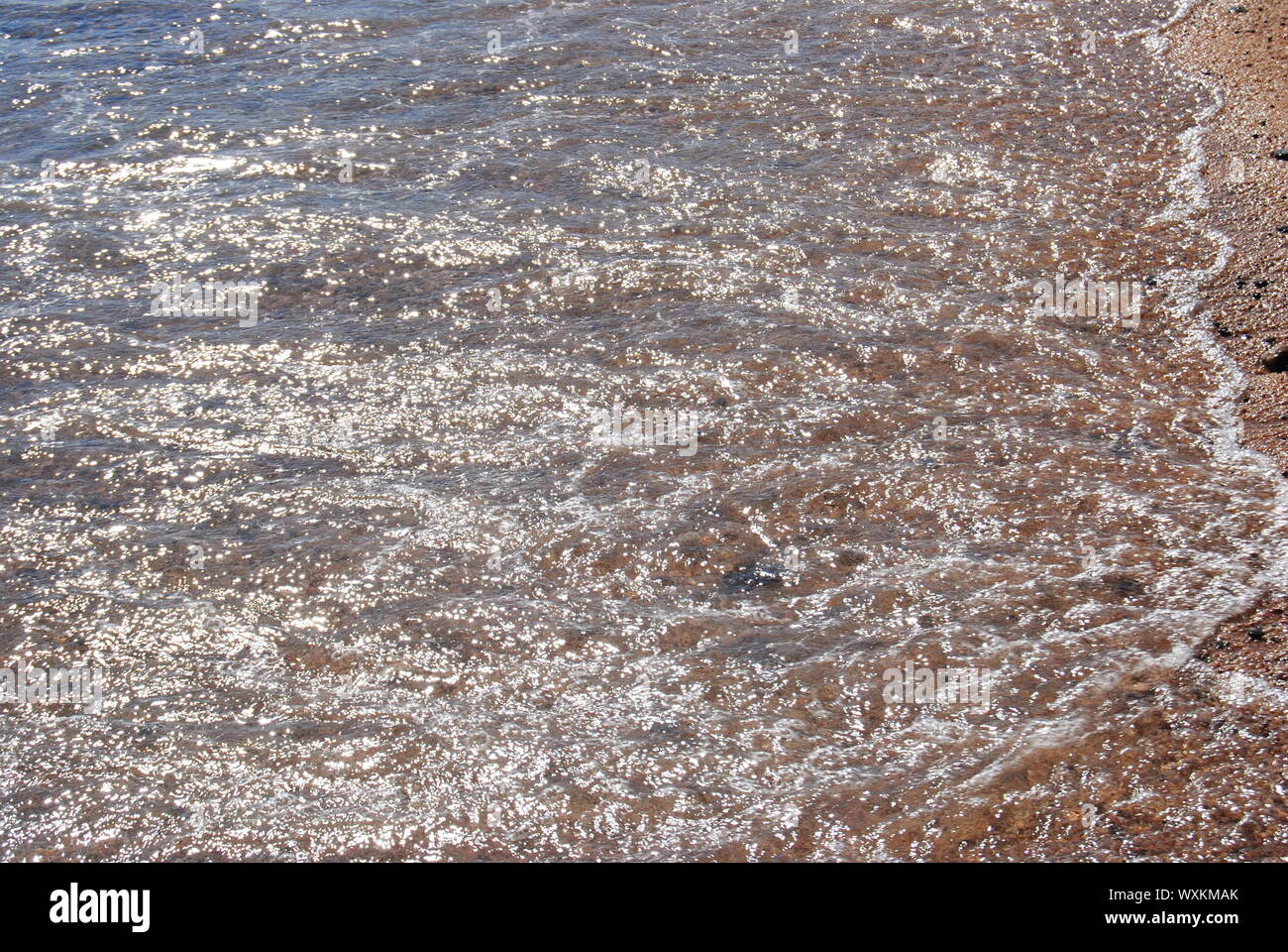 Waves and transparent water on the sand in the beach. Texture. Water ...