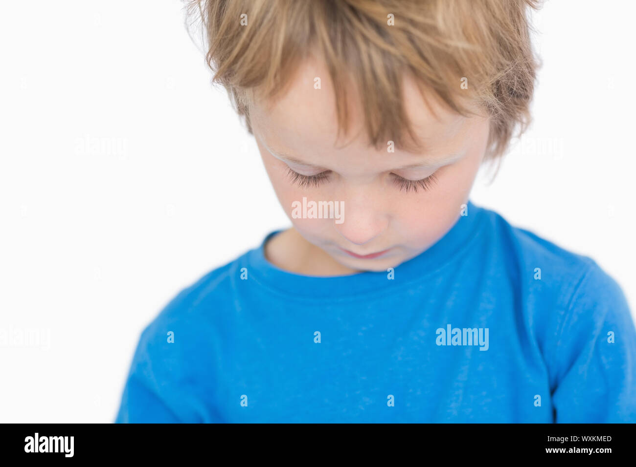 Closeup of a sad young boy over white background Stock Photo - Alamy