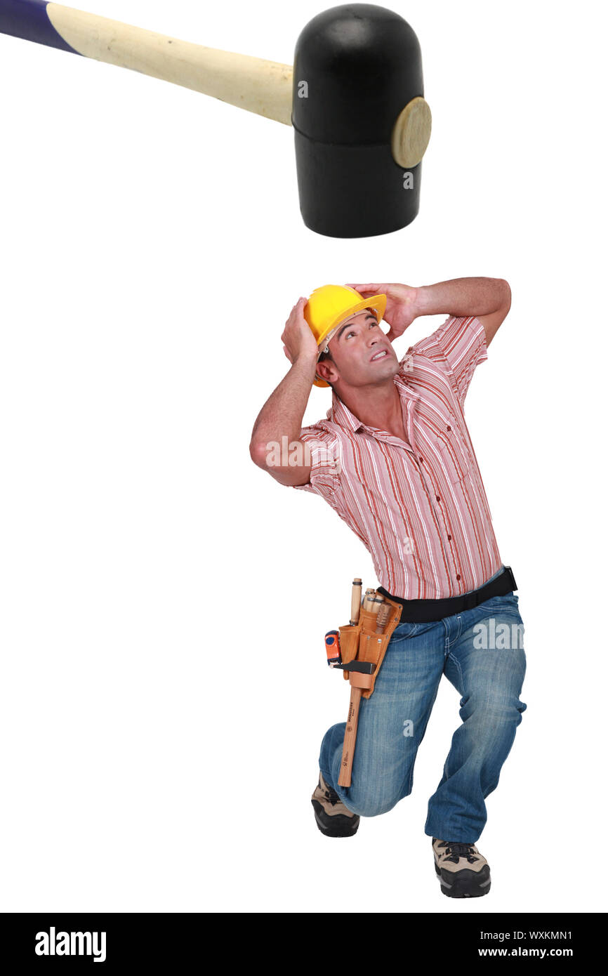 Panicked man being crushed by a giant hammer Stock Photo - Alamy