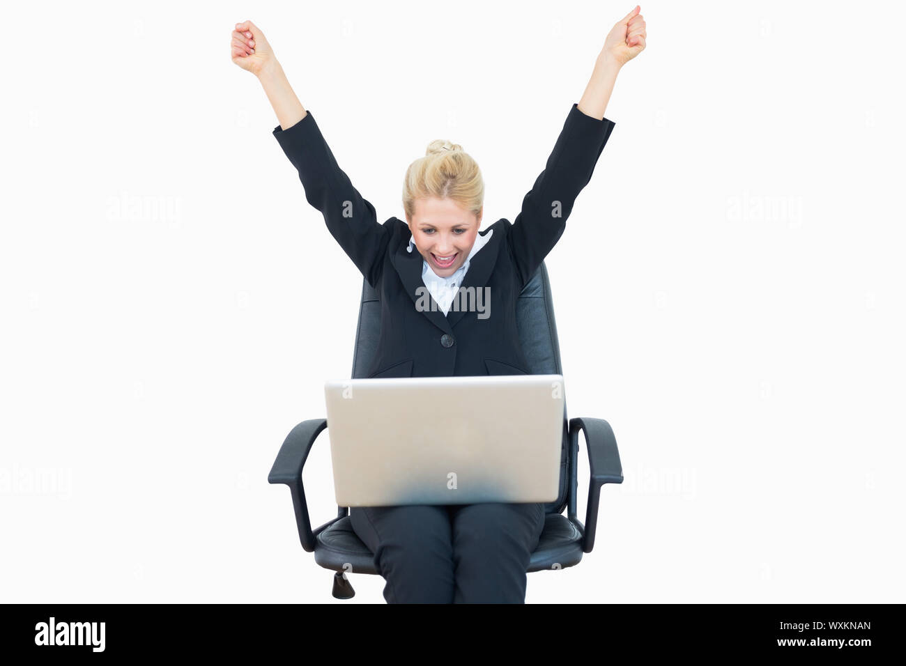 Successful young business woman raising hands in victory with laptop ...