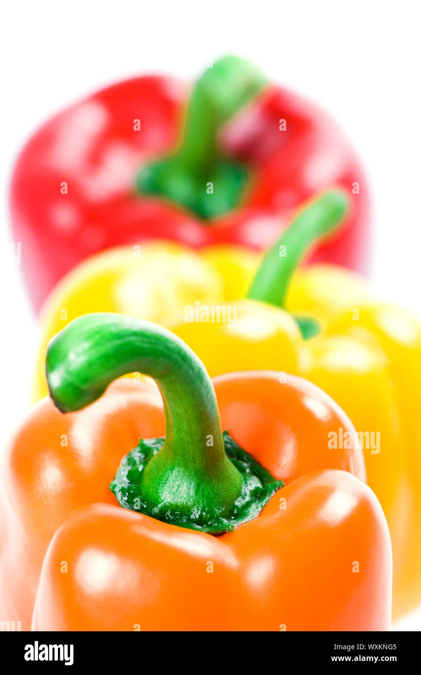 three bell peppers closeup on white background Stock Photo - Alamy