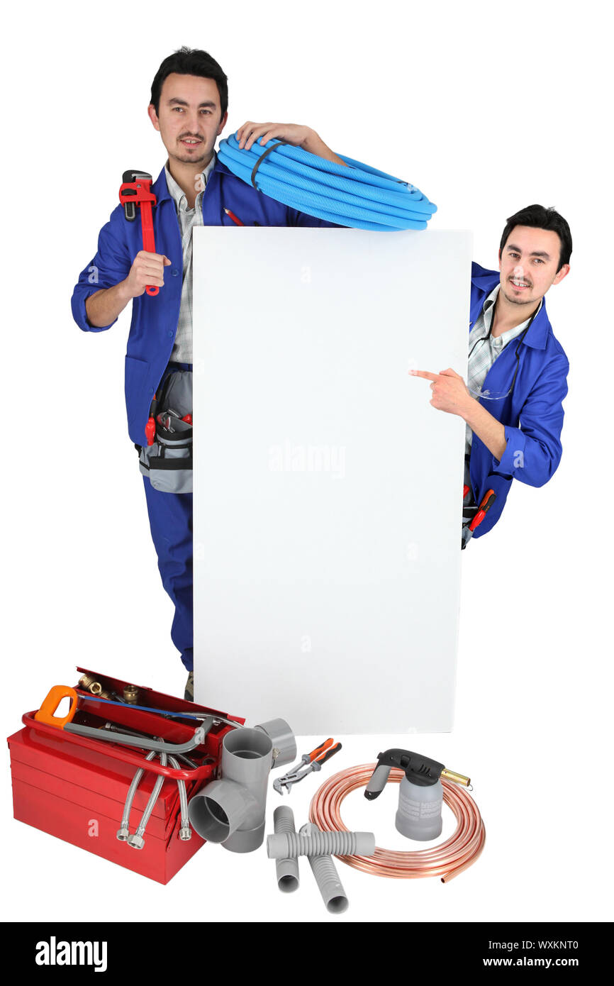 plumber with tools pointing at board Stock Photo - Alamy