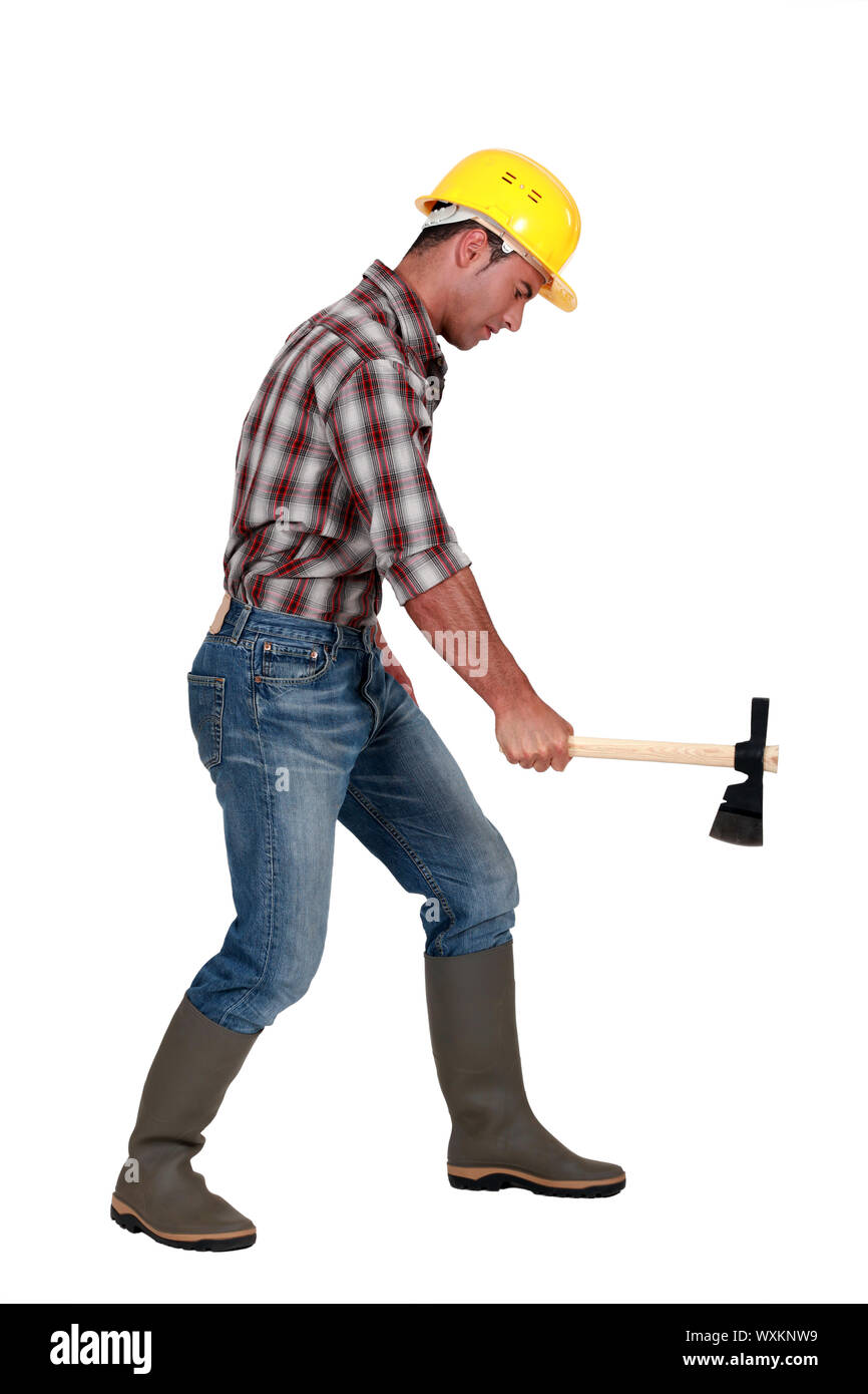 Tradesman using an axe to cut wood Stock Photo - Alamy