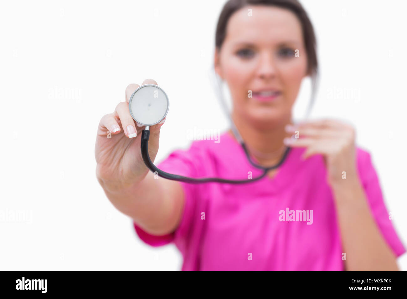 Nurse holding out stethoscope over white background Stock Photo - Alamy