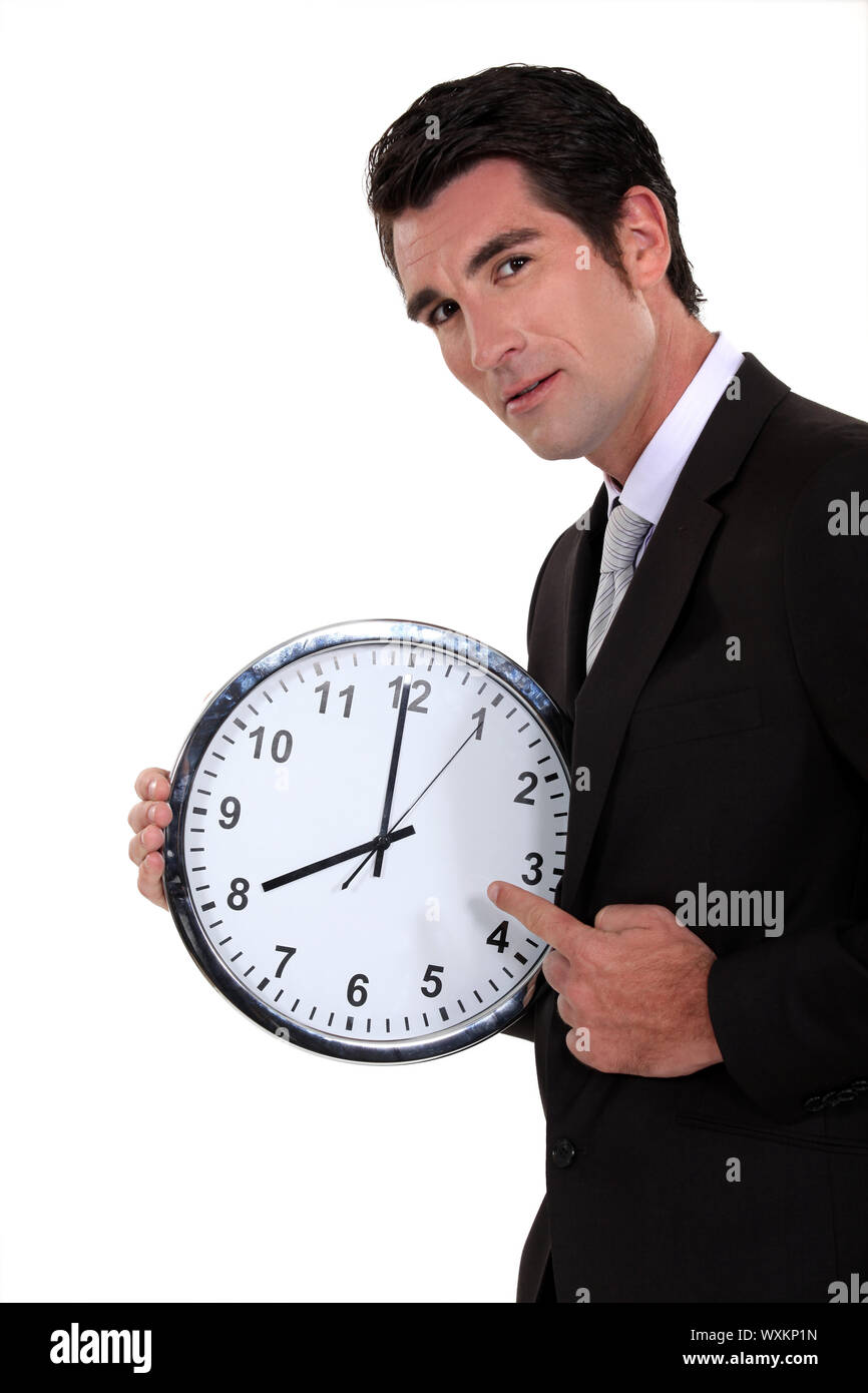 Man pointing to clock Stock Photo - Alamy