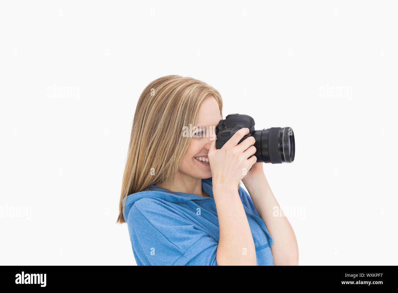 Side view of happy female photographer with photographic camera over ...