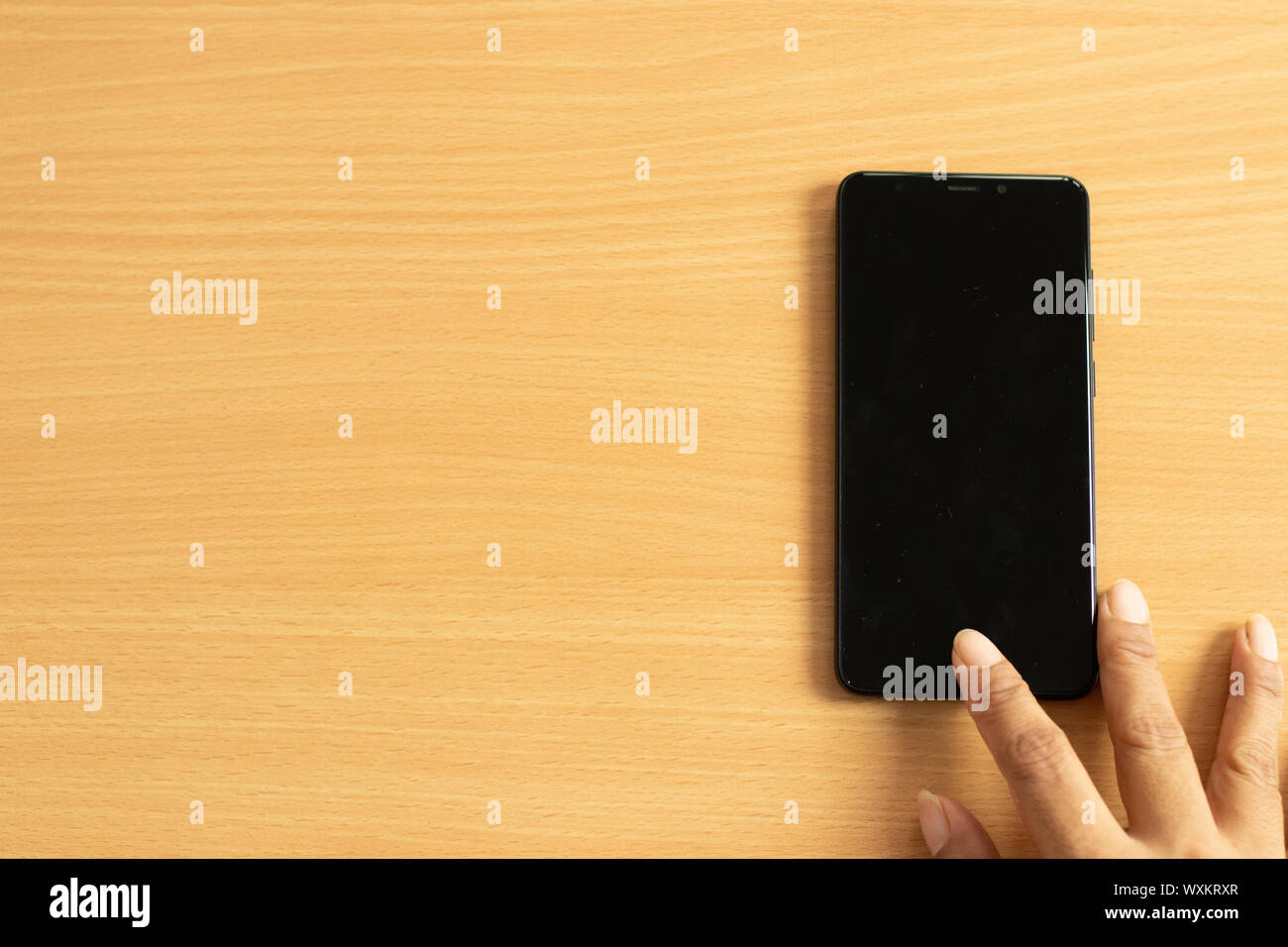 hand using phone light wood screen on top view Stock Photo - Alamy