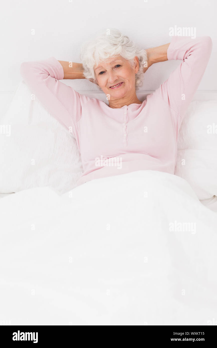 Smiling elderly woman in bed Stock Photo - Alamy