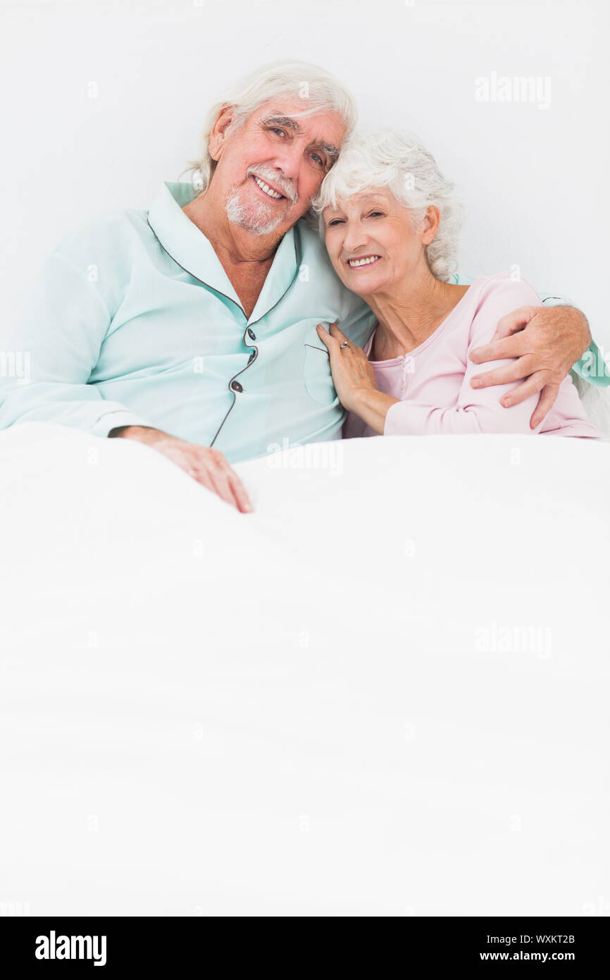 Happy old couple sitting in bed Stock Photo - Alamy