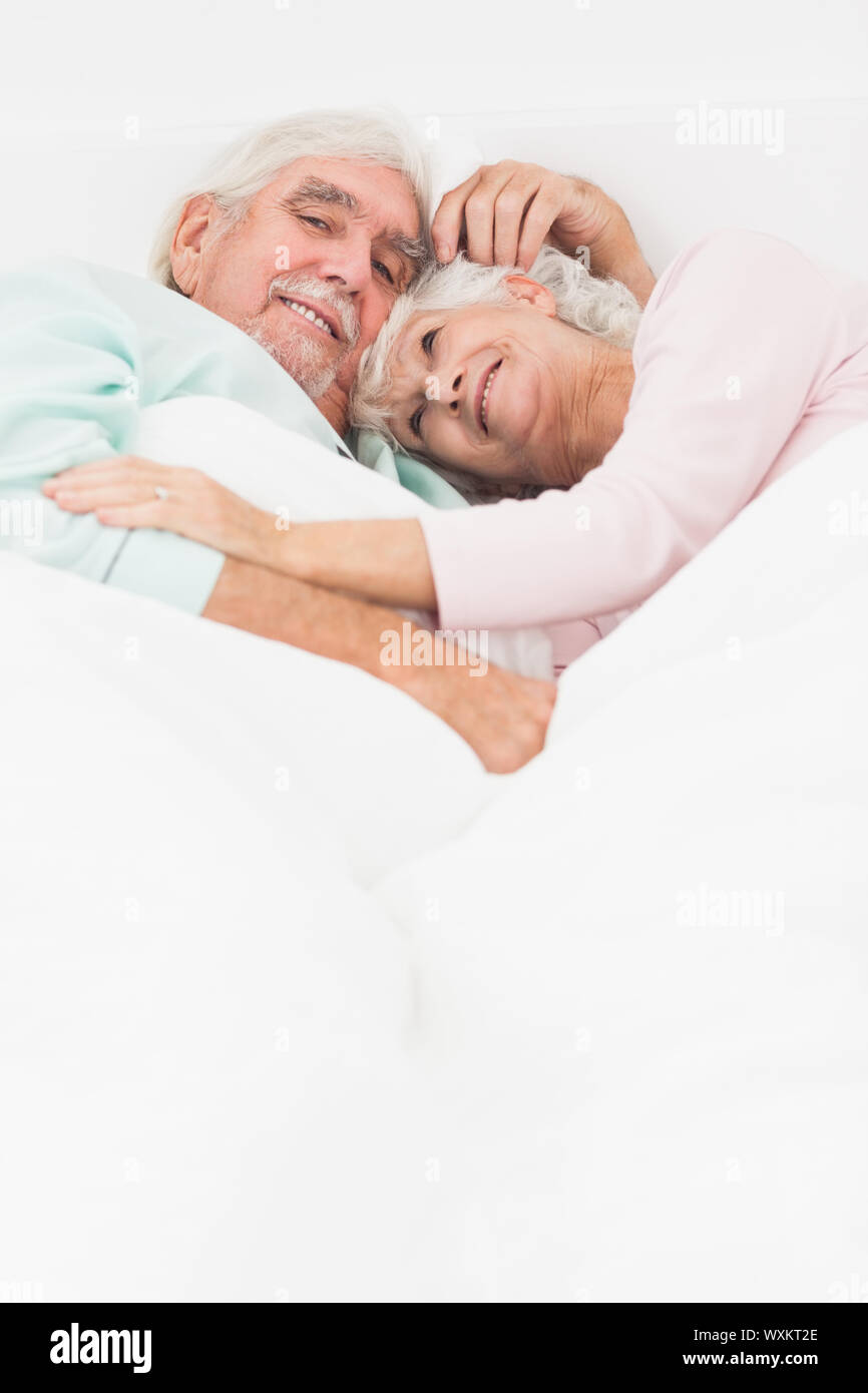 Mature couple cuddle bed hi-res stock photography and images - Alamy