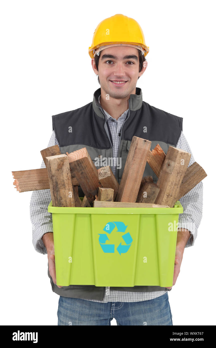 A construction worker recycling wooden scraps Stock Photo - Alamy