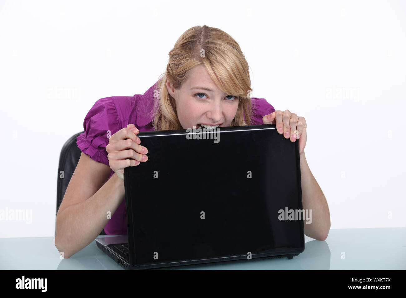 Frustrated woman biting her laptop hi-res stock photography and images ...