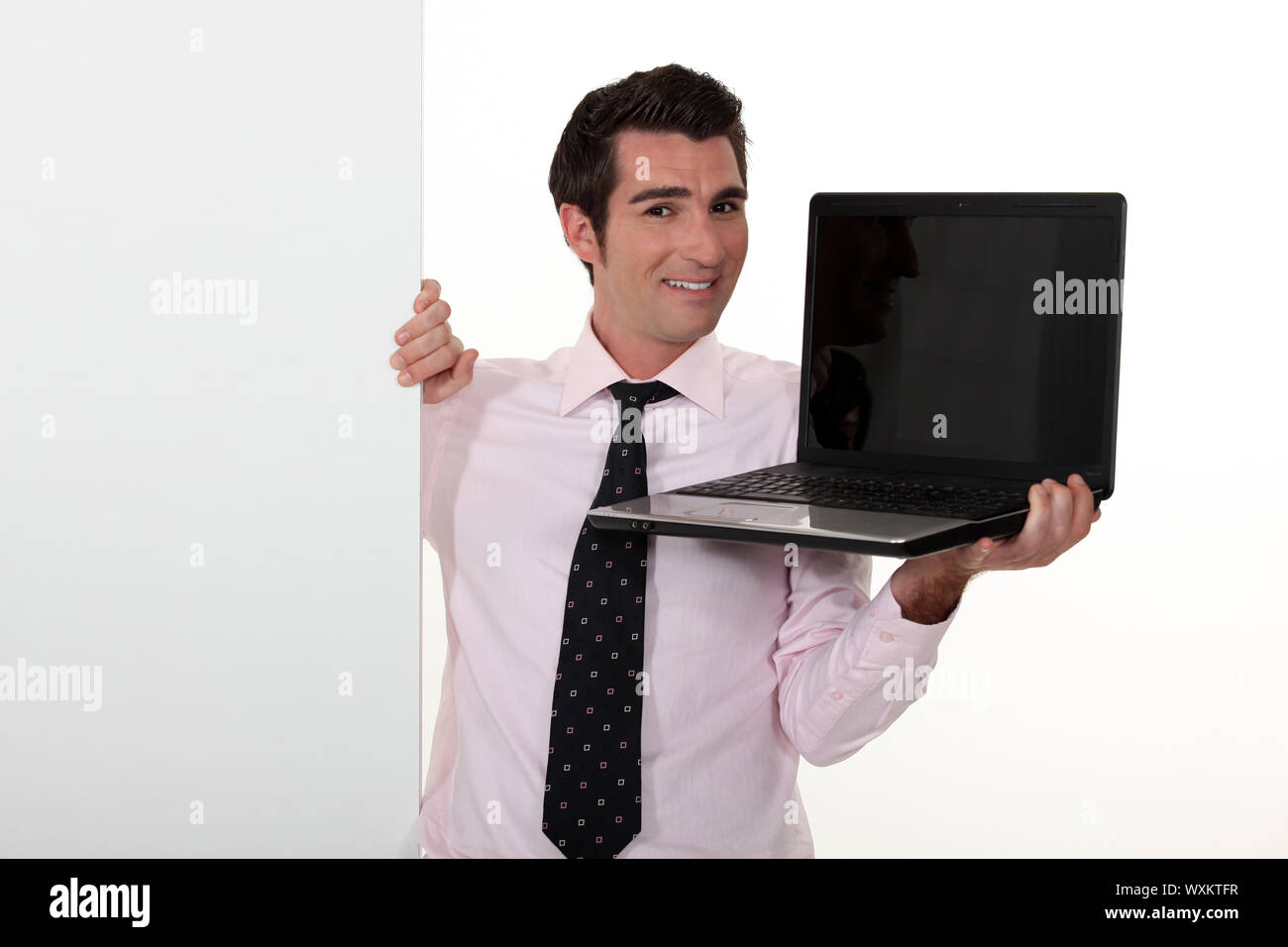 Man in smart suit showing notebook Stock Photo - Alamy