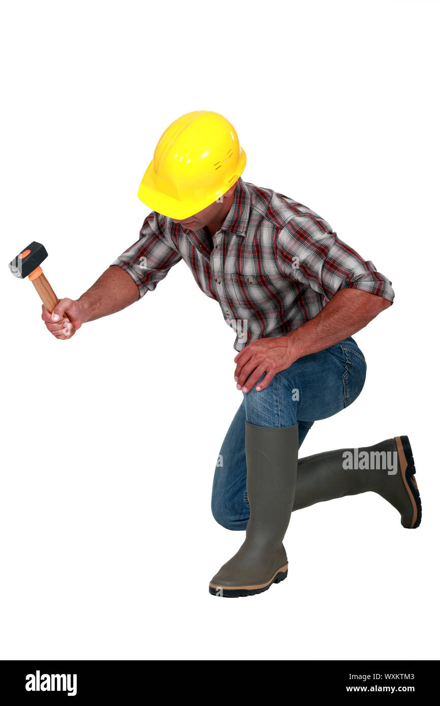 A construction worker with a hammer Stock Photo - Alamy