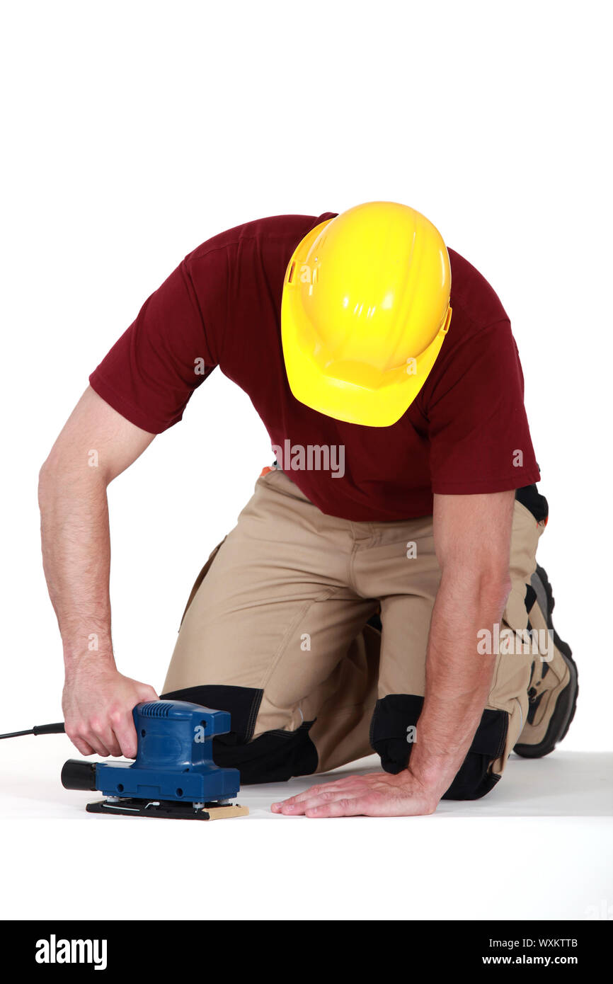 Builder using sander on floor Stock Photo - Alamy