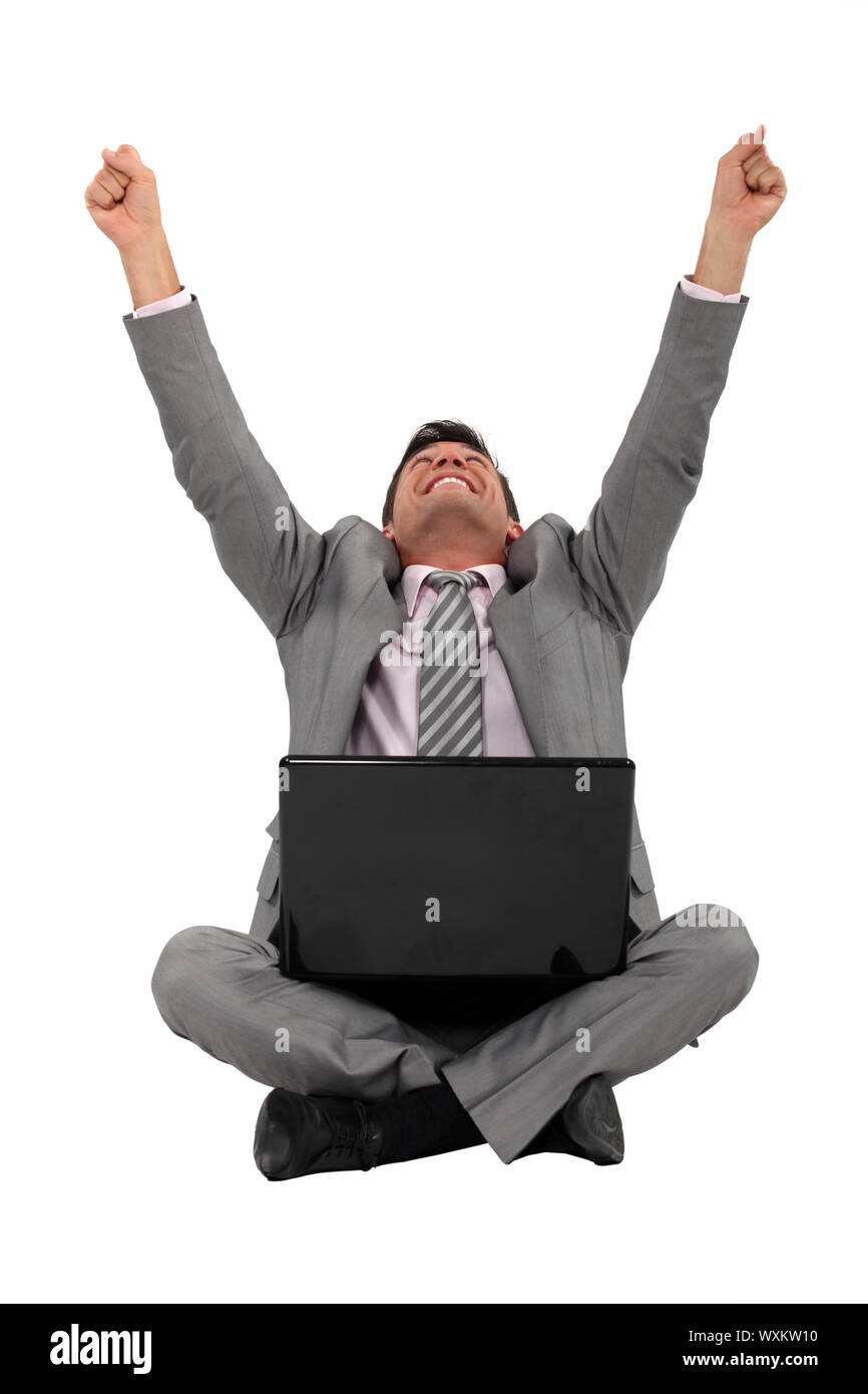 Happy worker in front of computer Stock Photo - Alamy