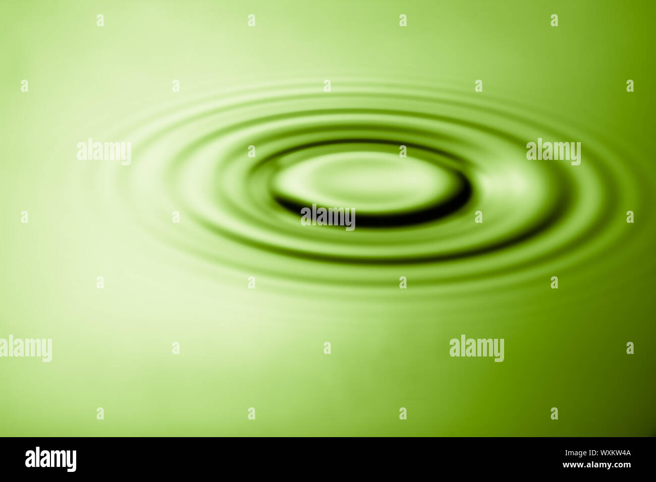 Ripple effect in water in green Stock Photo - Alamy