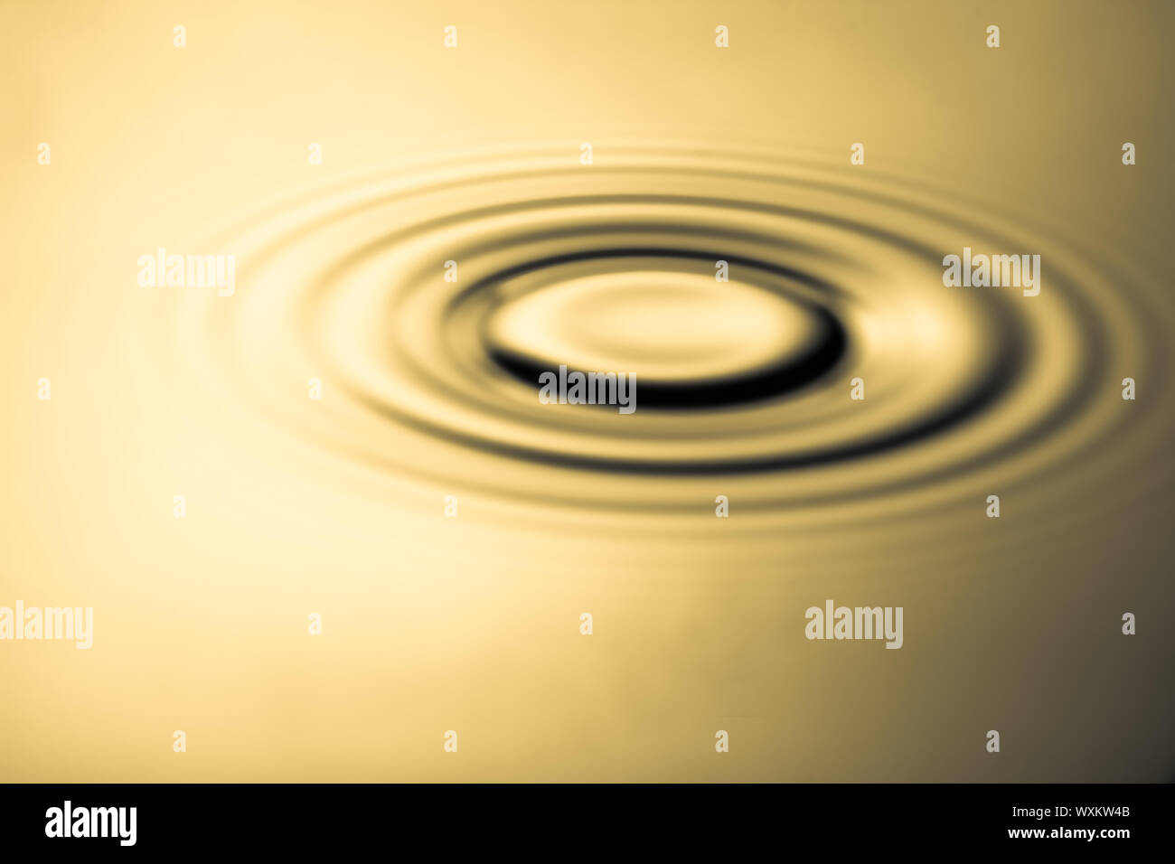 Yellow ripple effect in water Stock Photo - Alamy