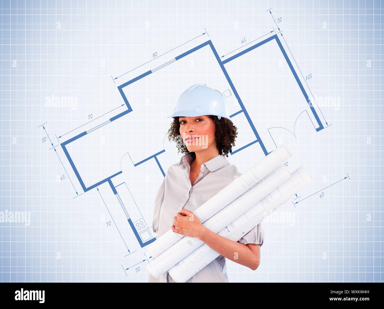 Confident architect holding plans against digital blueprint background ...