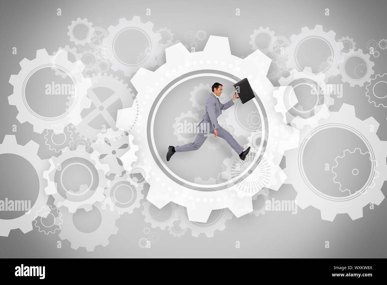 Businessman running with briefcase with wheels and cogs graphic on grey ...