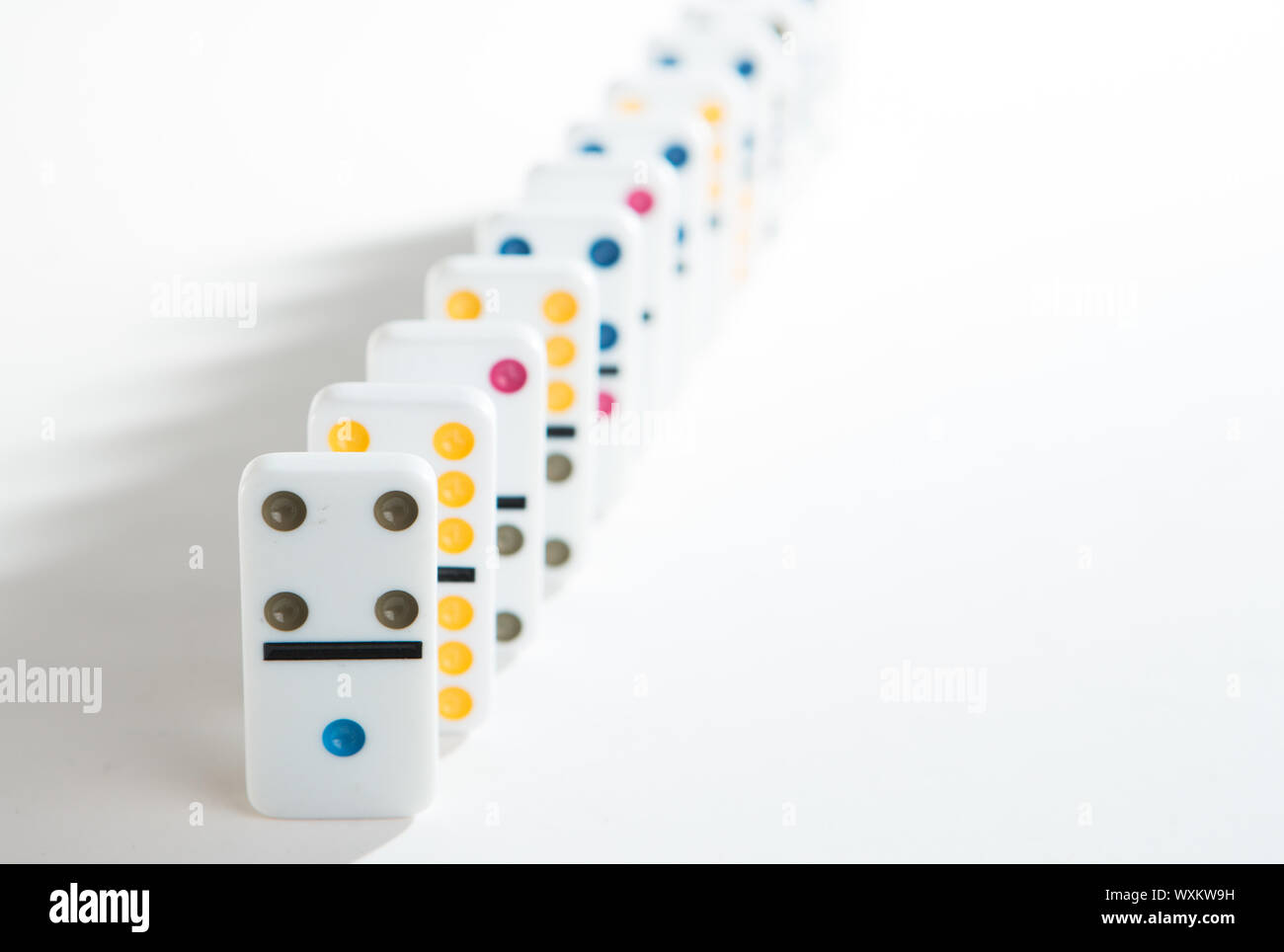 Line of colourful dominoes on white background with shadows Stock Photo ...
