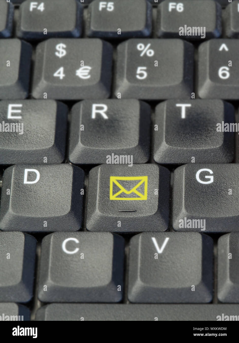 Yellow email shortcut button on black keyboard Stock Photo - Alamy
