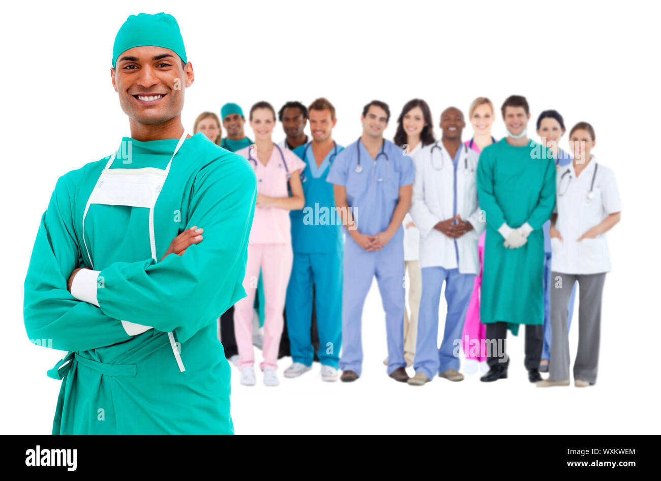 Smiling surgeon with medical staff behind him on white background Stock ...