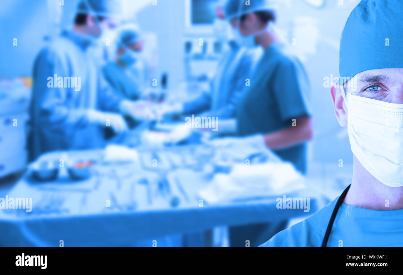 Portrait of a doctor standing in operating room in front of an ...
