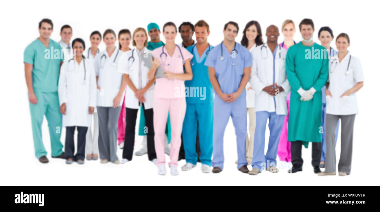 Happy team of smiling doctors standing together on a white background ...