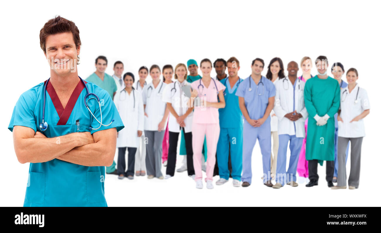 Smiling surgeon in front of a team of doctors standing together on a ...