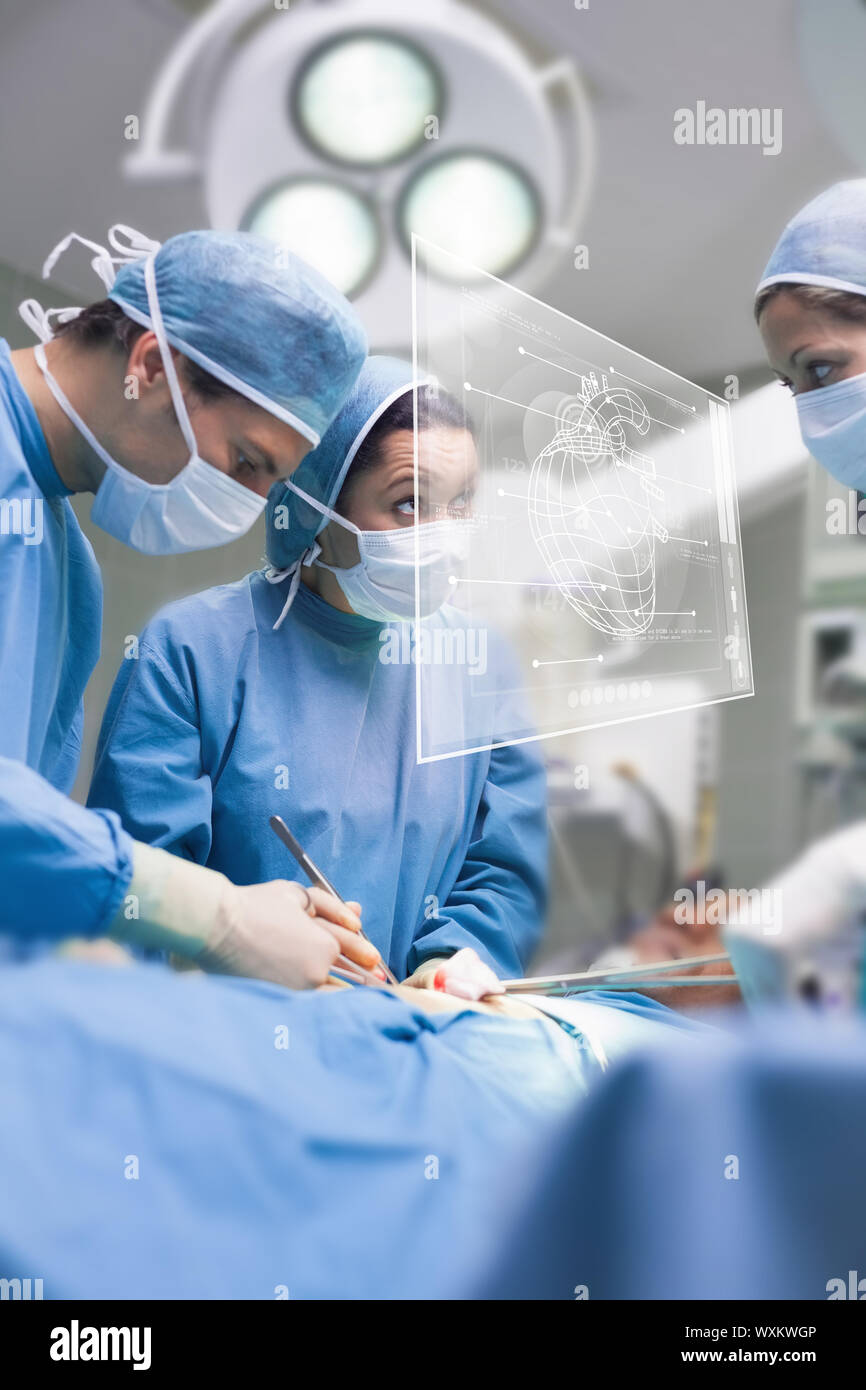 Concentred surgons operating with a touchscreen on a hospital Stock ...