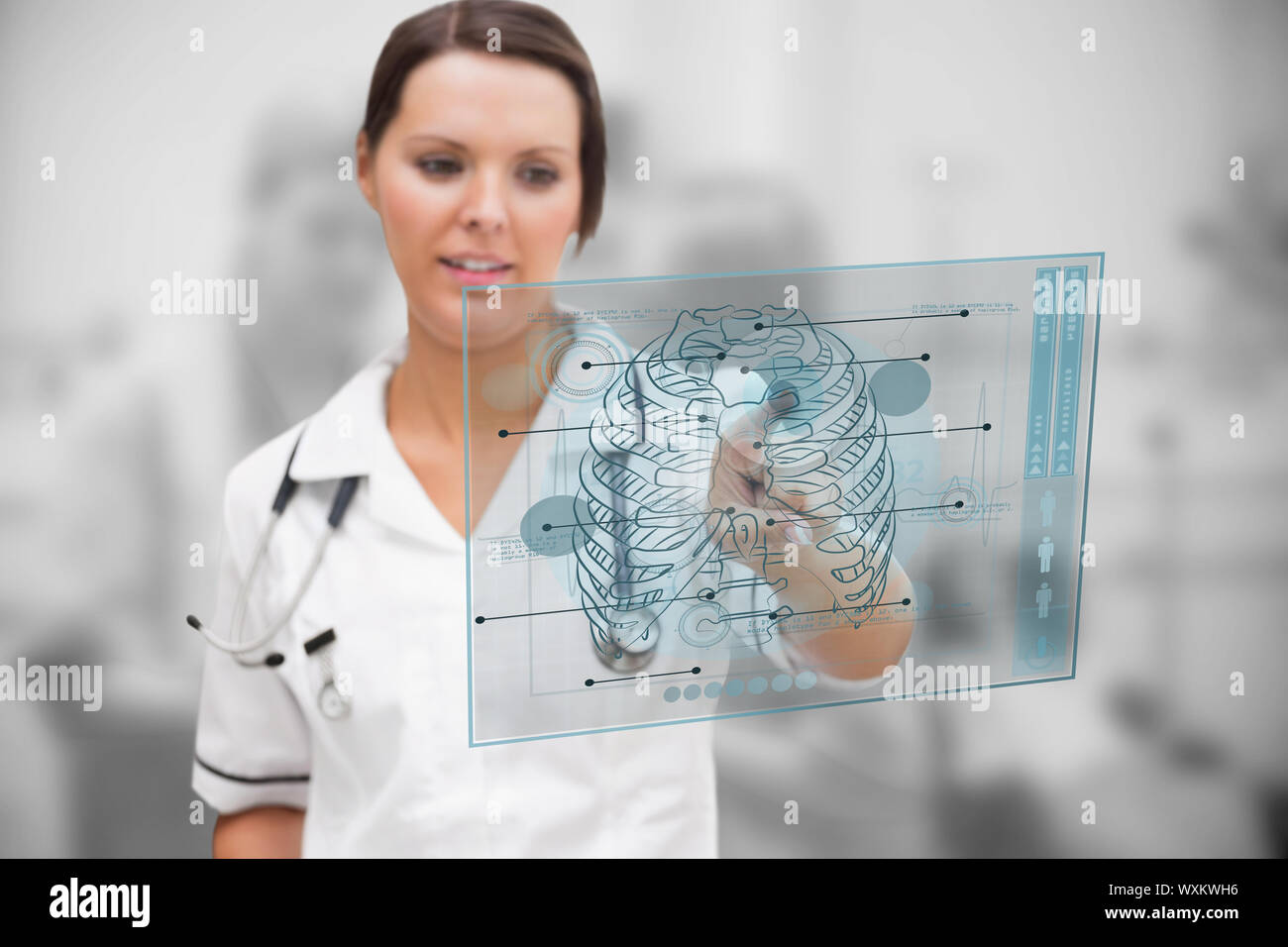 Concentrated nurse working on a medical interface in the hospital Stock ...