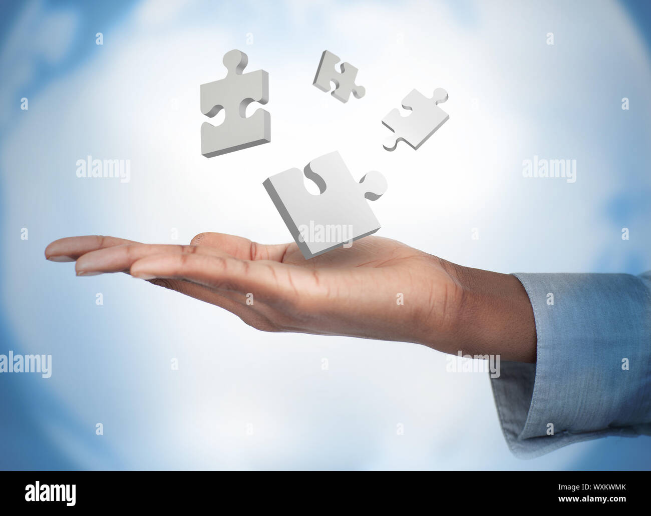 Hand with digital white puzzles against a digital background Stock ...