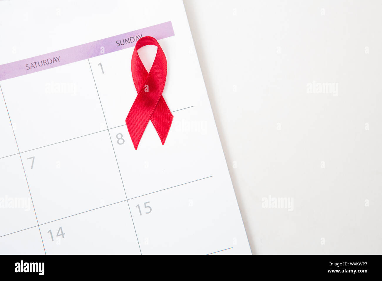 Red awareness ribbon marking world aids day on white calendar Stock ...