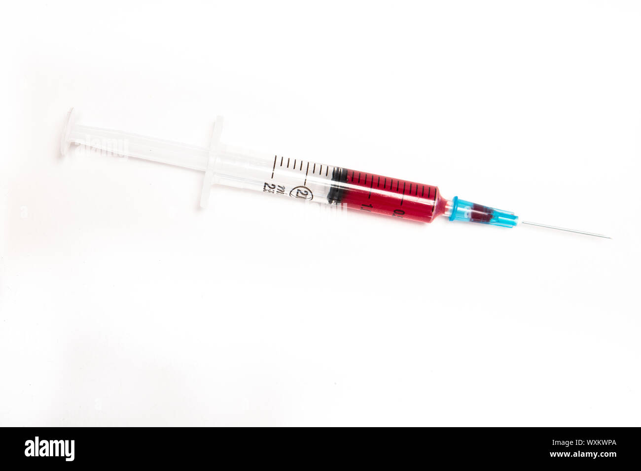 Syringe filled with blood on white background Stock Photo - Alamy
