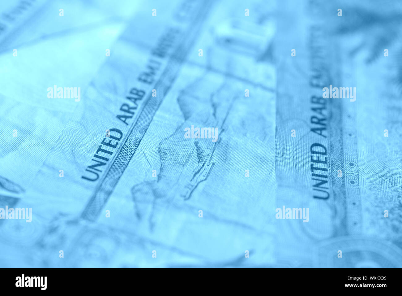 United Arab Emirates banknotes close up blue color toned Stock Photo ...