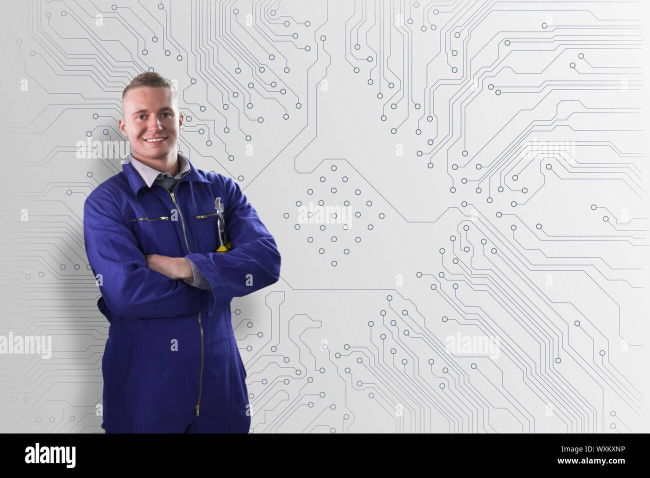 Smiling mechanic standing in front of a circuit board background Stock ...