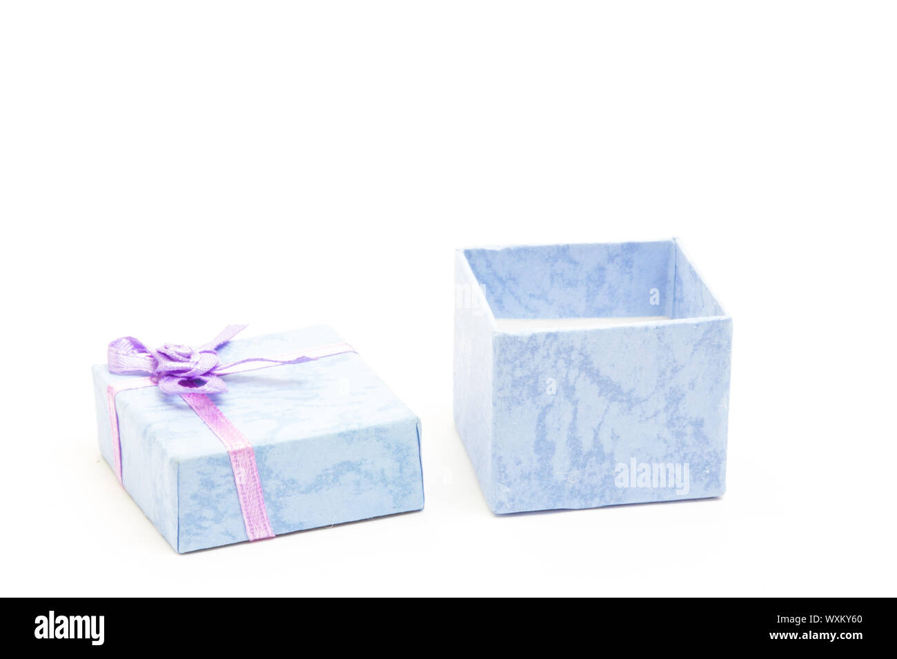 Open blue gift box with purple ribbon on white background Stock Photo ...