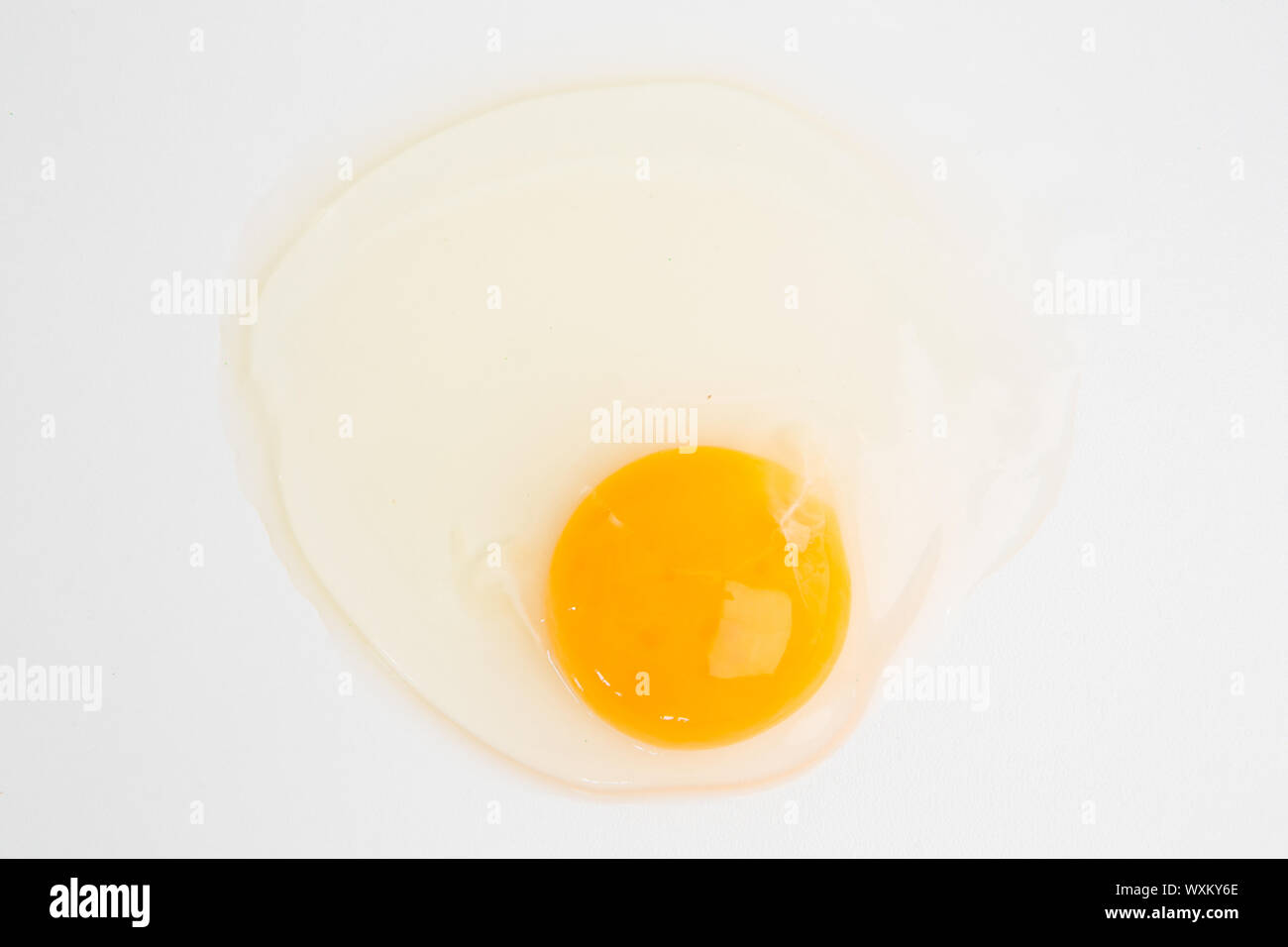 Raw egg on white background Stock Photo - Alamy