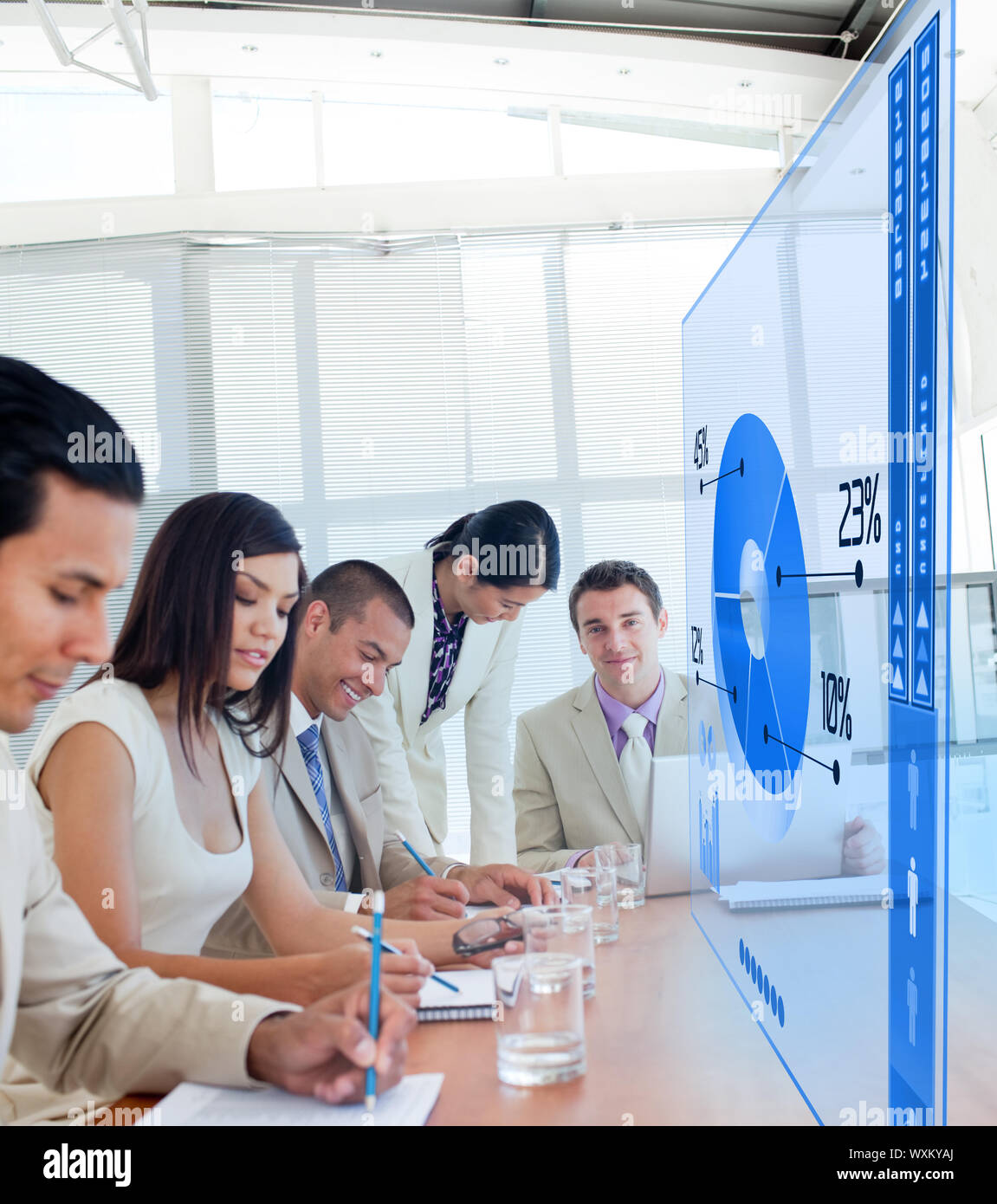 Group of colleagues using blue pie chart interface in a meeting Stock ...