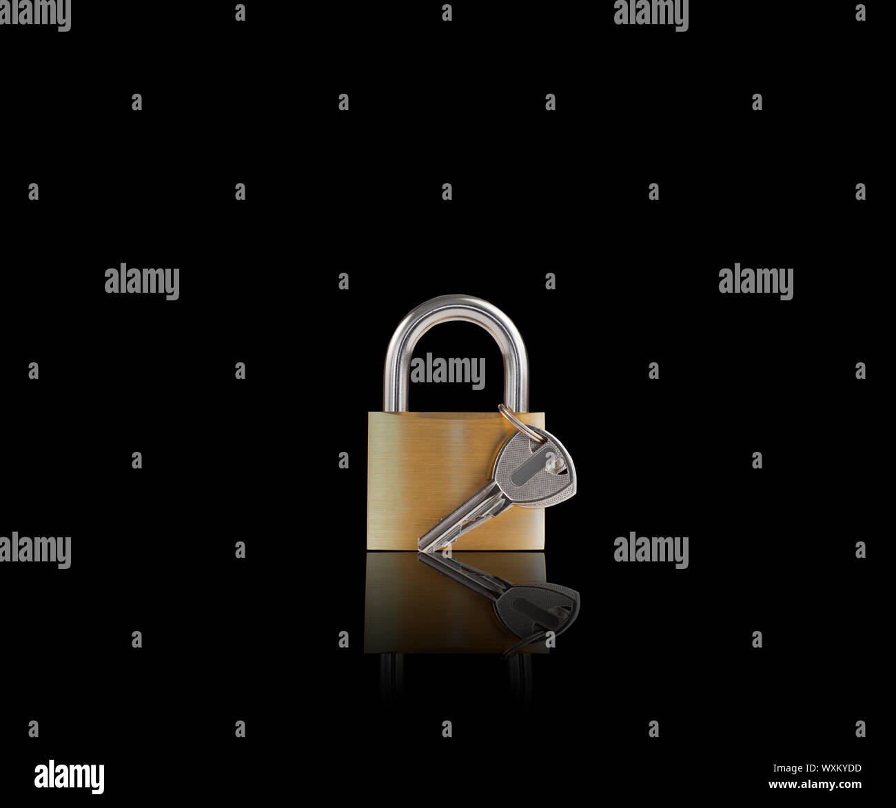 Locked padlock with key on black background Stock Photo - Alamy