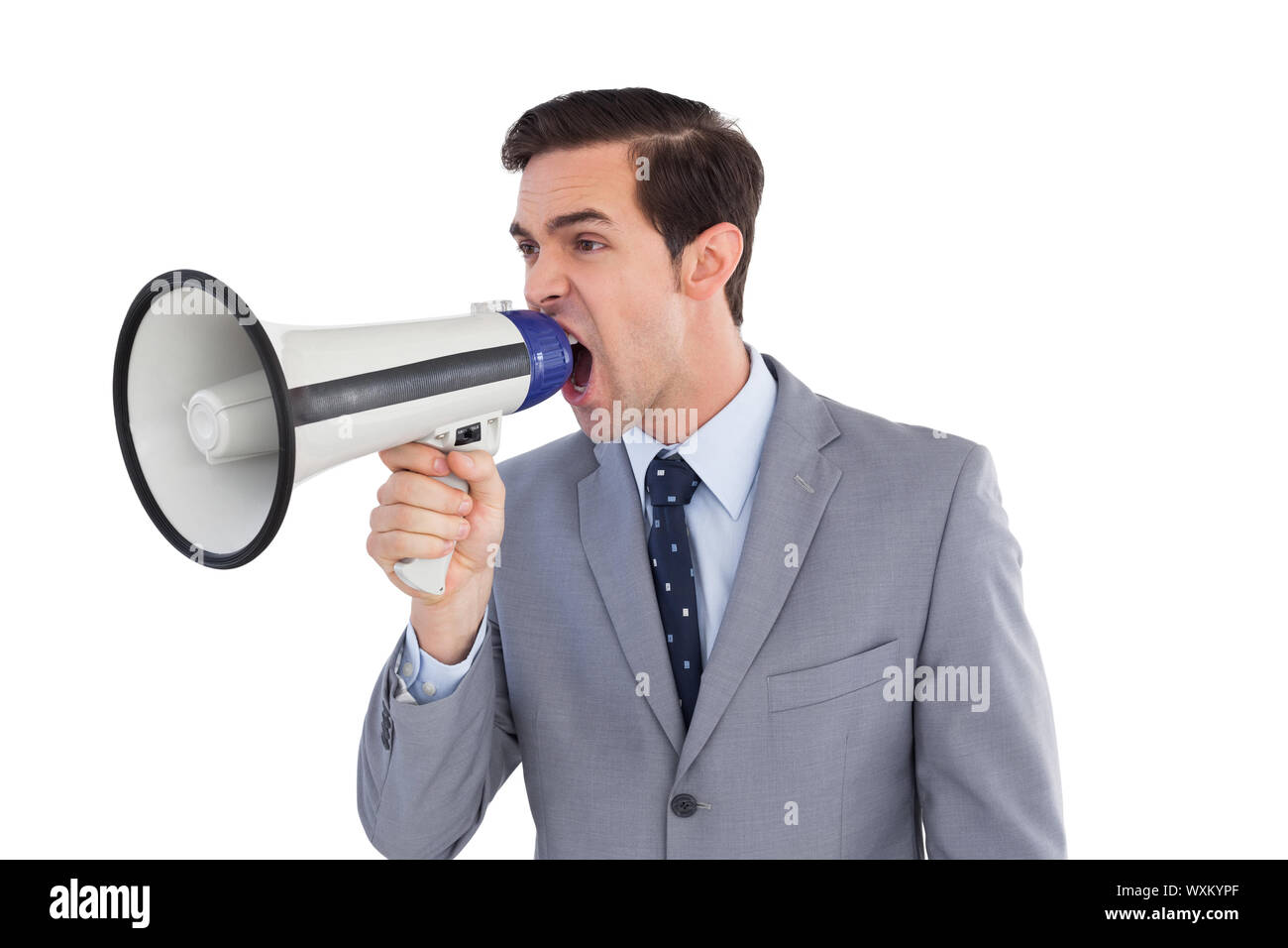 Businessman yelling into a megaphone on white background Stock Photo ...