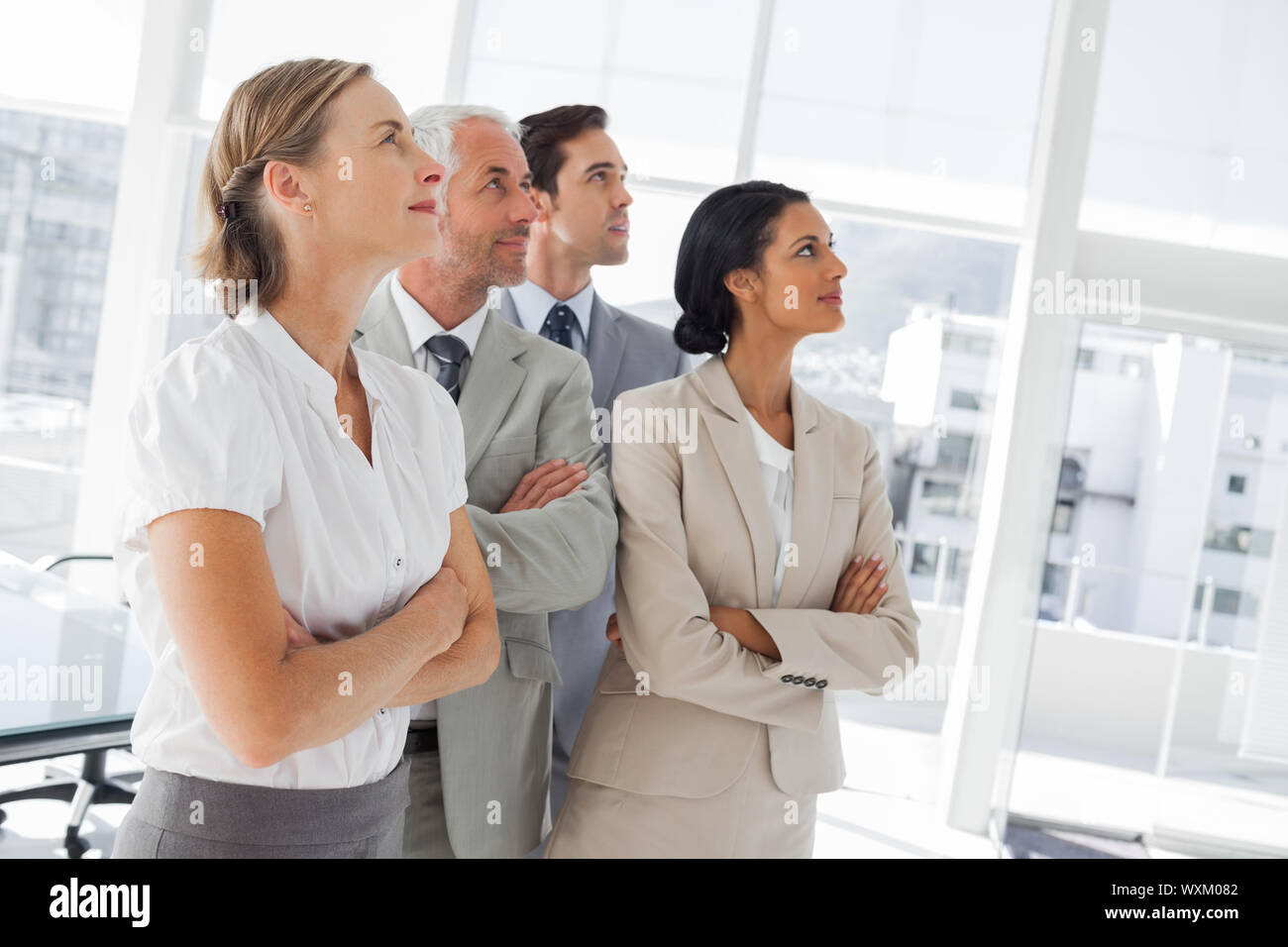 Confident business people looking at the same way in the workplace ...