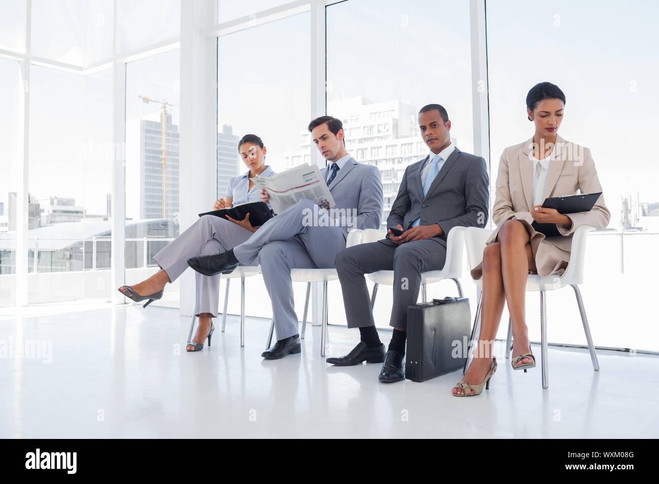 Business people sitting in waiting room with big windows Stock Photo ...