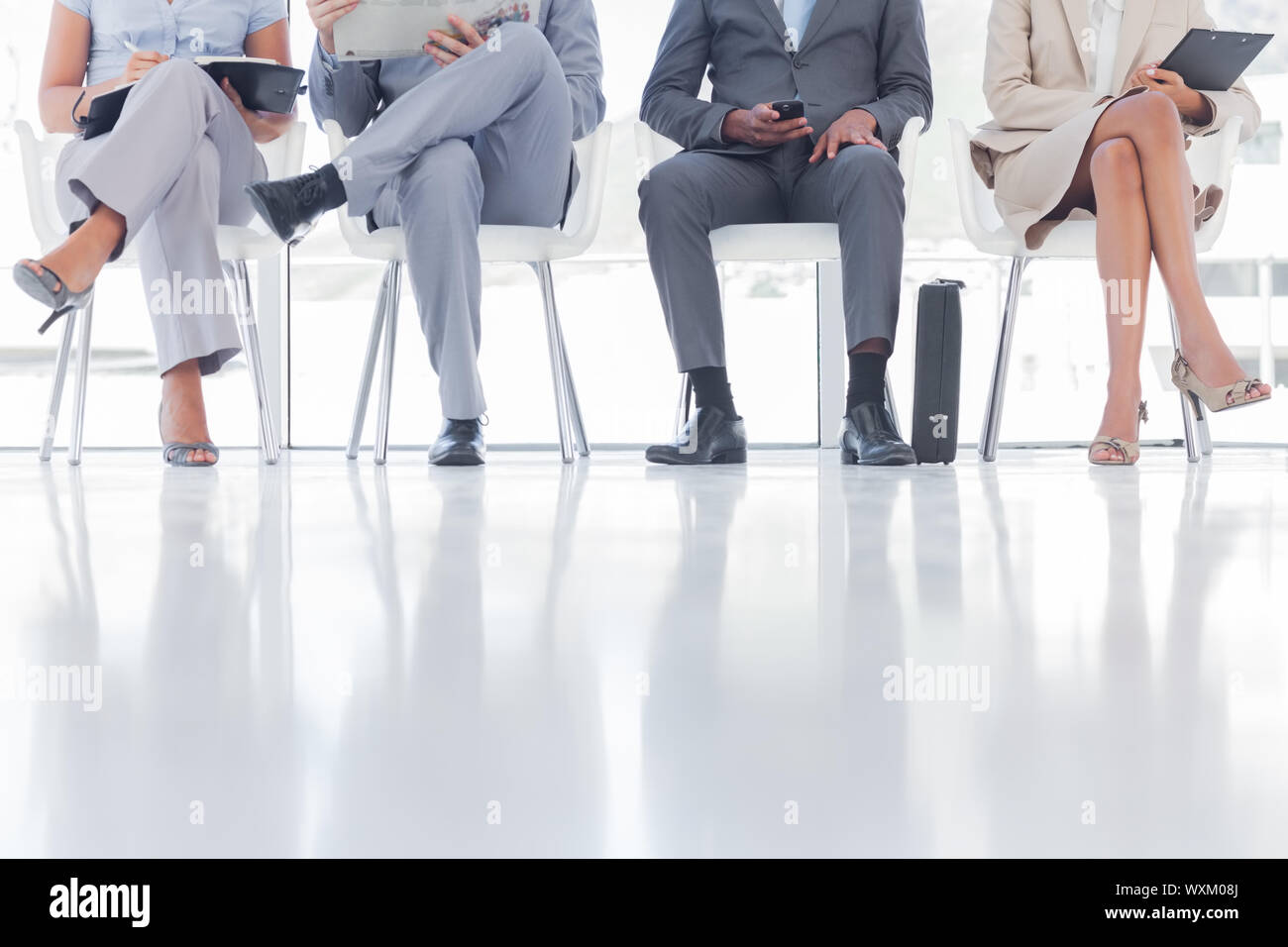 Group of business people waiting together in a waiting room Stock Photo ...