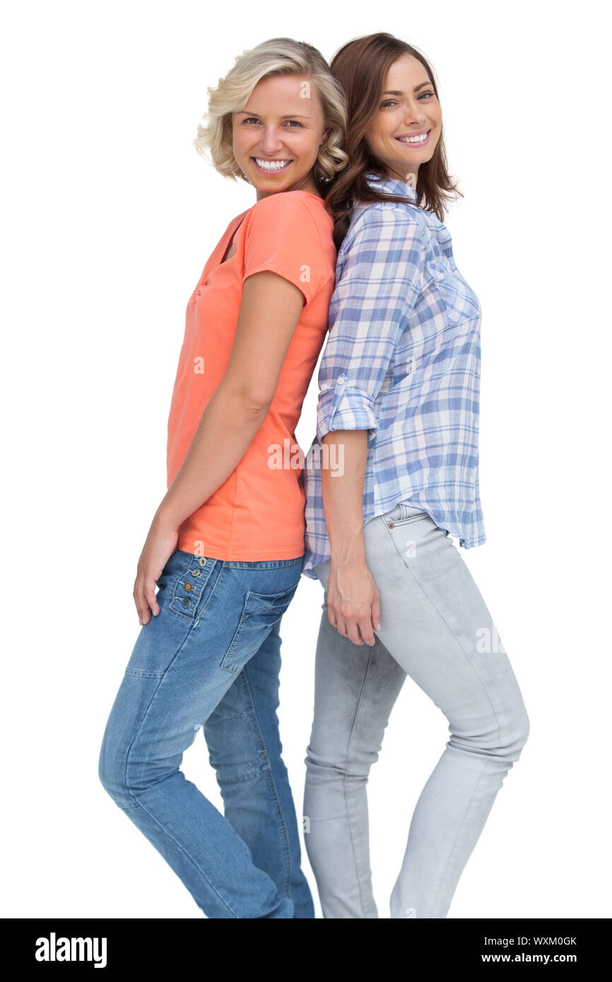 Two friends back to back on white background Stock Photo - Alamy