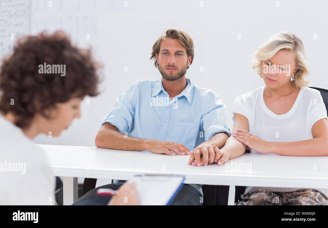 Psychologist taking notes while couple speaks Stock Photo - Alamy