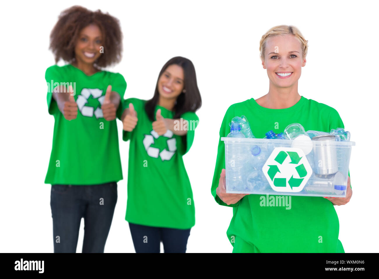 Smiling activist holding recycling box with friends giving thumbs up ...